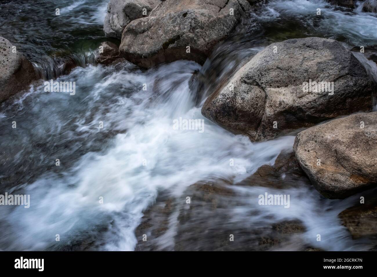 detail of a mountain river flowing between rocks, long exposure silk ...