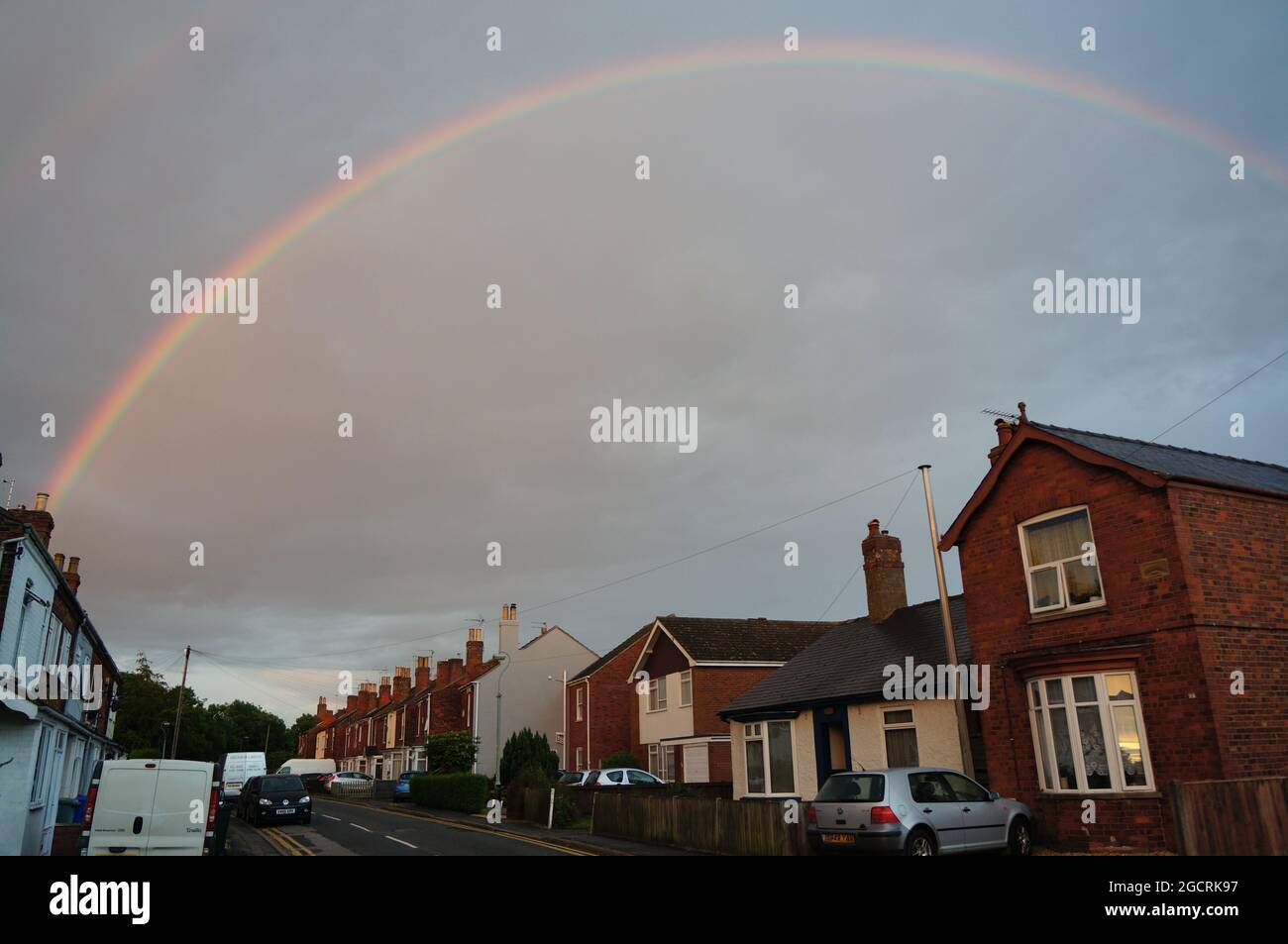 Suburban street with a full rainbow in the sky Stock Photo - Alamy