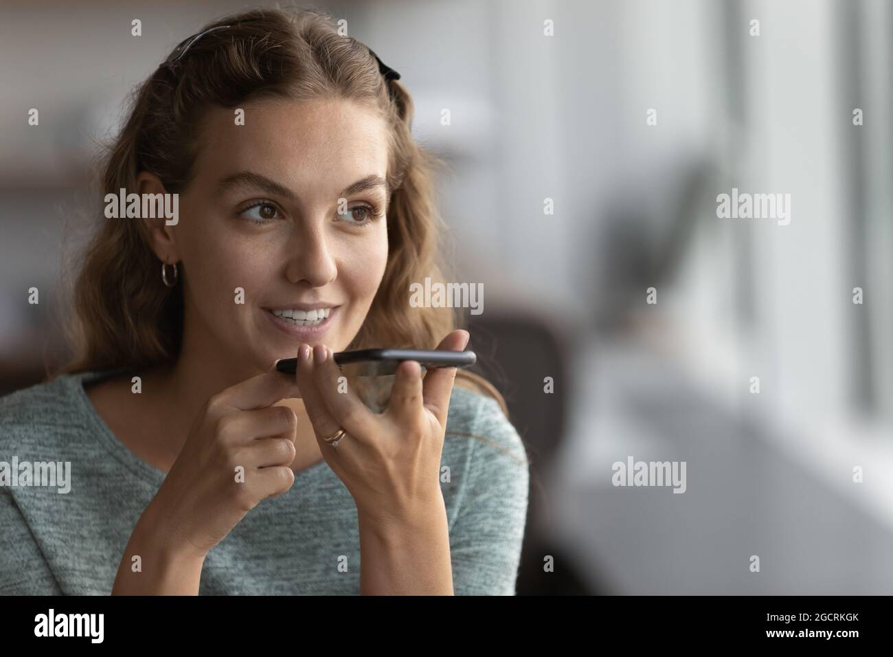 Happy gen Z girl recording audio message on smartphone Stock Photo - Alamy