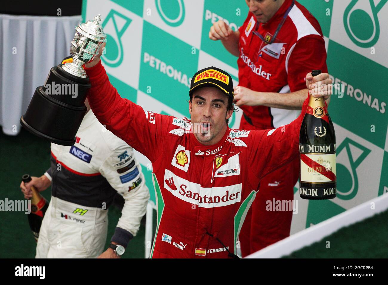 Race winner Fernando Alonso (ESP) Ferrari celebrates on the podium ...