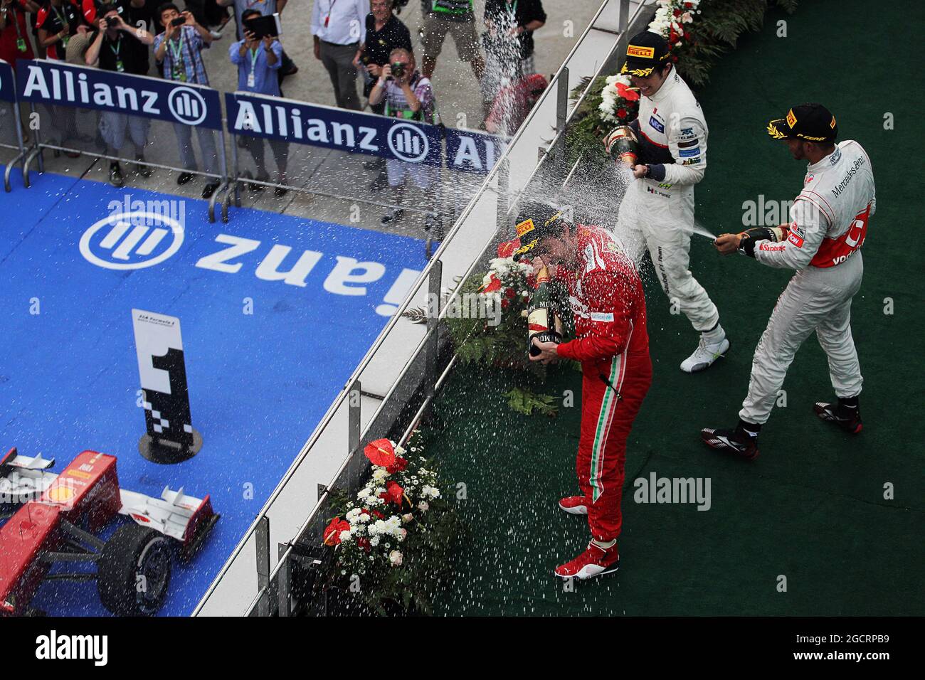 Celebrates on the podium with perez and alonso hi-res stock photography ...