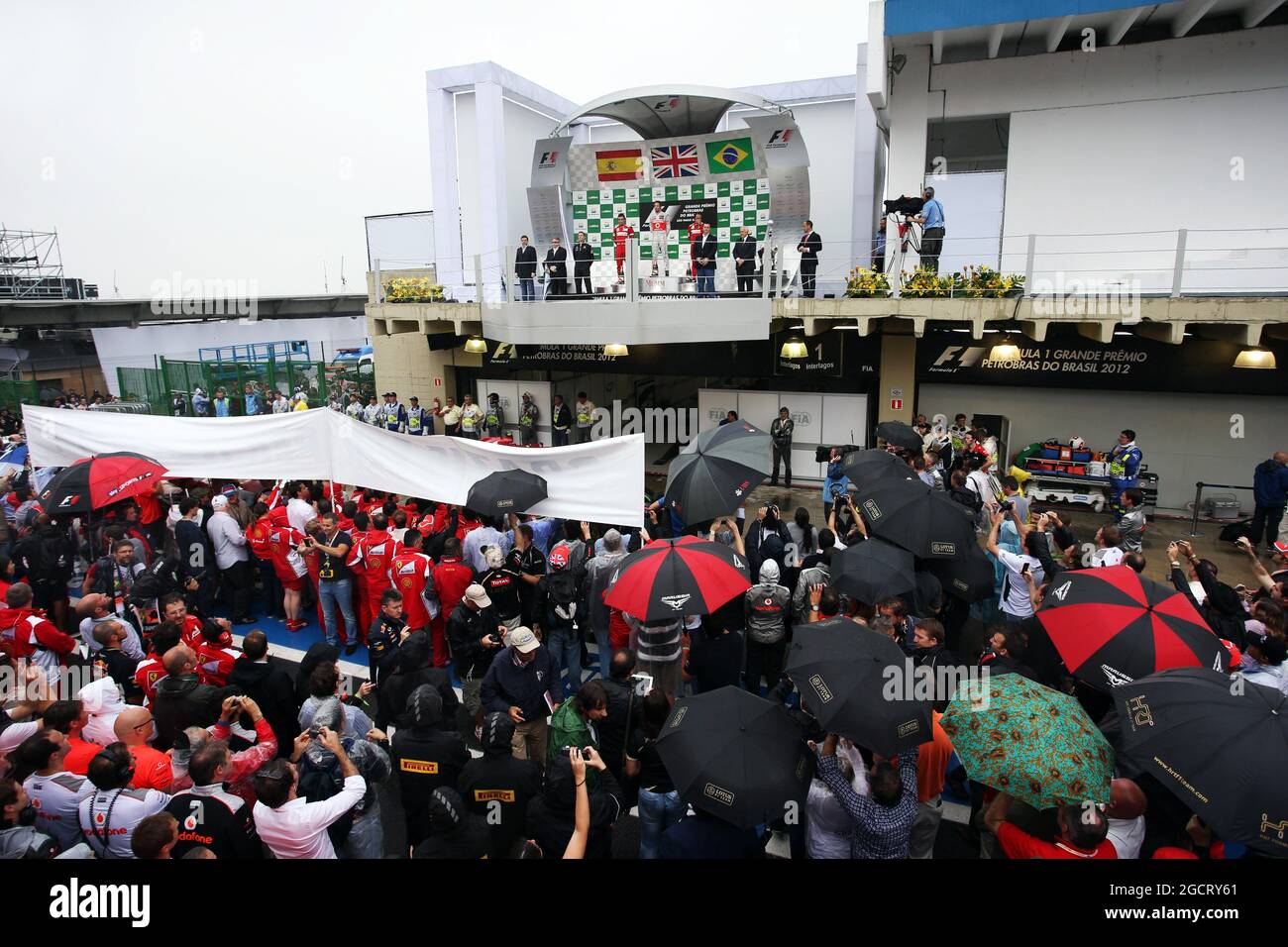 The podium (L to R): Fernando Alonso (ESP) Ferrari, second; Jenson ...