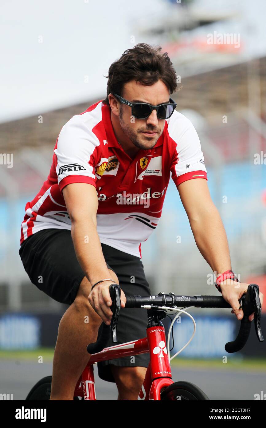 Fernando Alonso (ESP) Ferrari rides the circuit on his bicycle ...