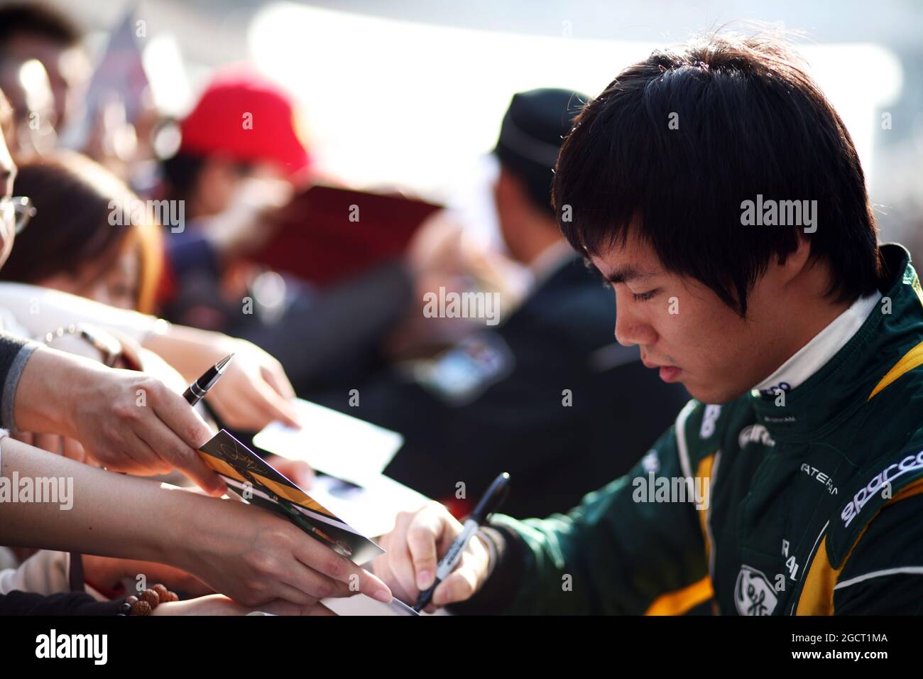 Ma Qing Hua (CHN) Caterham F1 Reserve Driver signs autographs for the ...