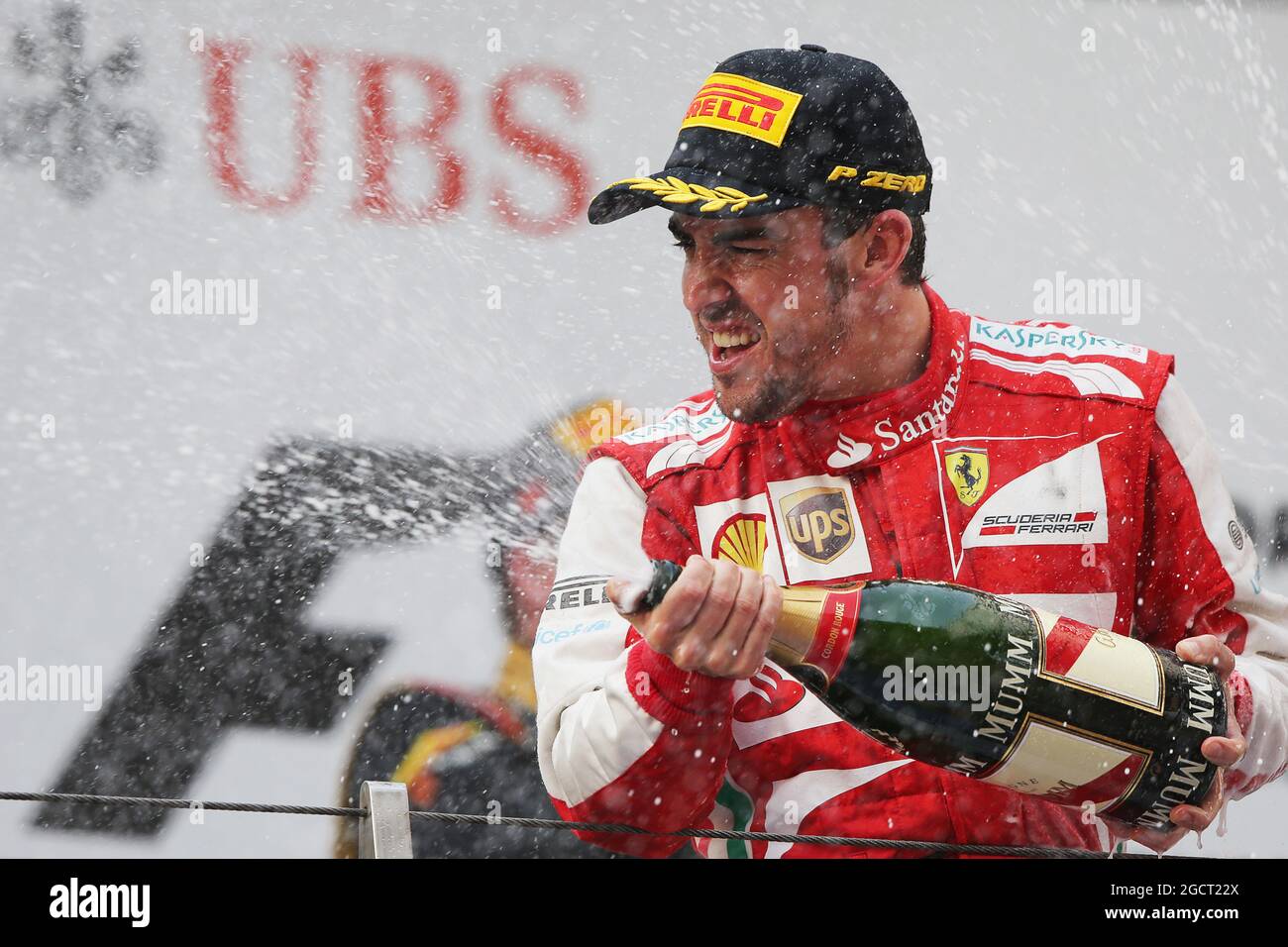 Race winner Fernando Alonso (ESP) Ferrari celebrates on the podium ...