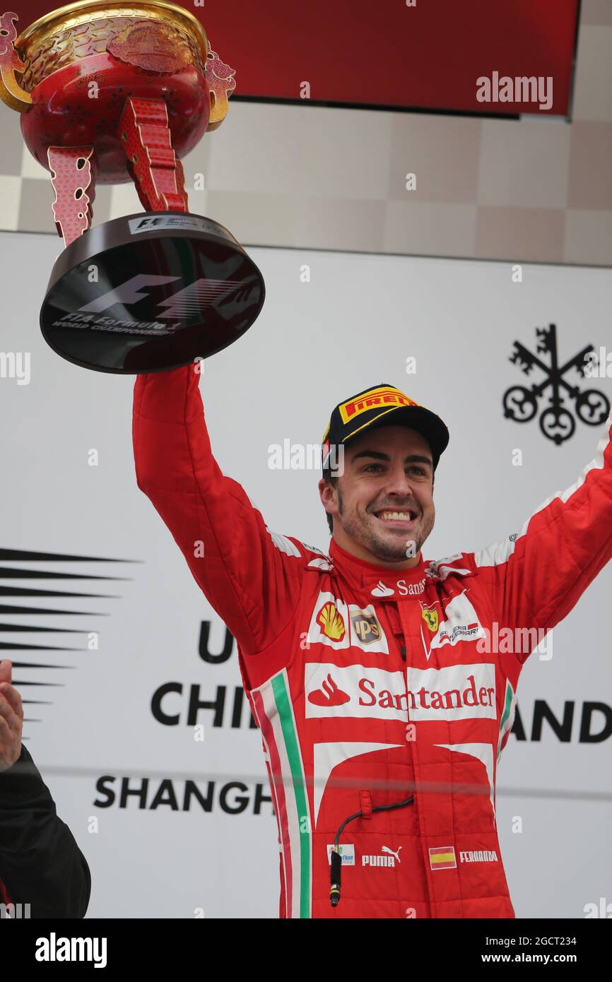 Race winner Fernando Alonso (ESP) Ferrari celebrates on the podium ...