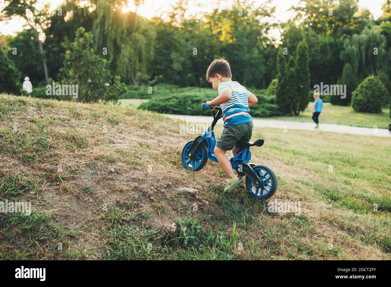 Beautiful boy in a field on bike. Outdoor recreation. Sport, healthy ...