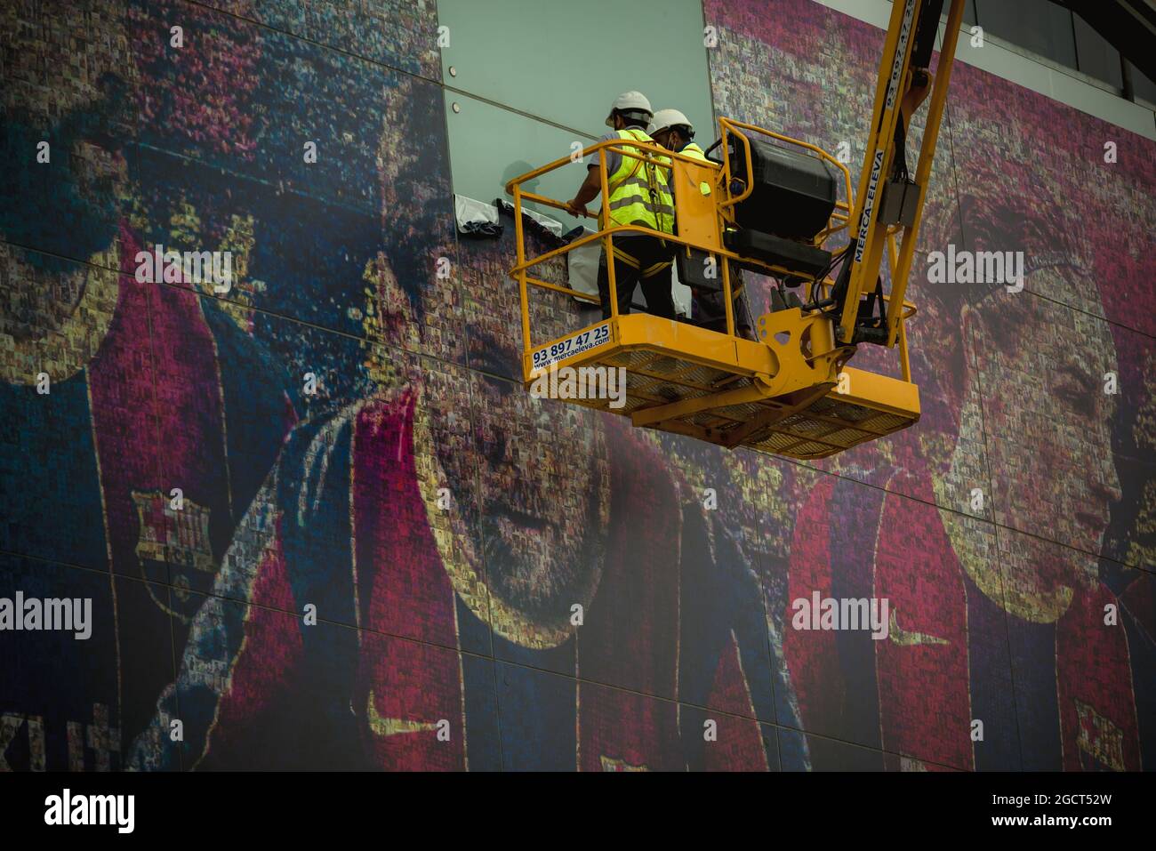 Barcelona, Spain. 10th Aug, 2021. Workers remove the portrait of Messi ...