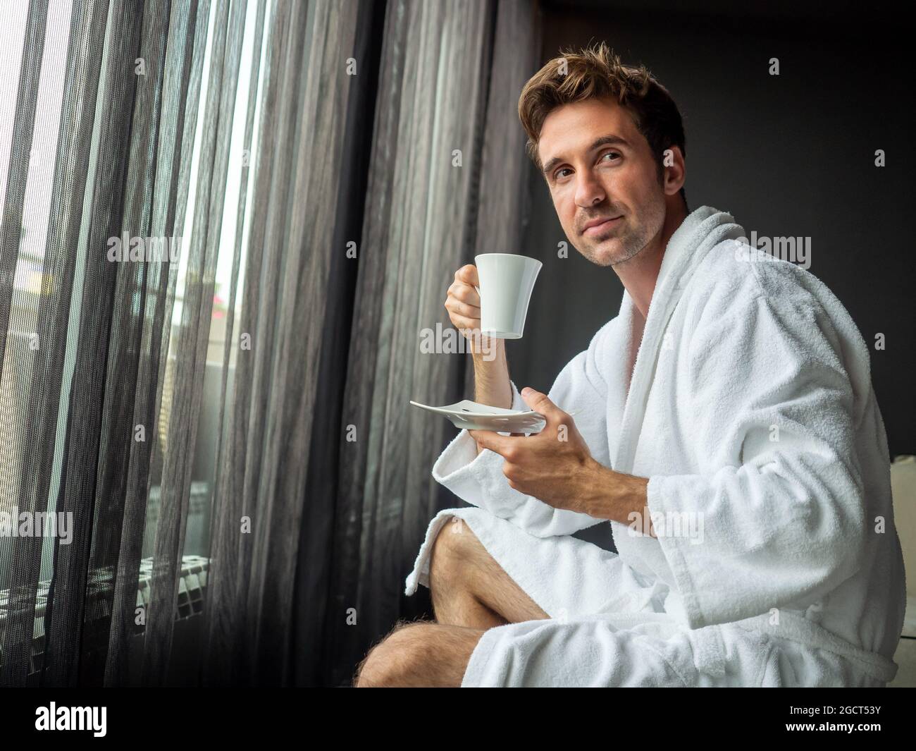 Man in bathrobe drinking coffee hi-res stock photography and images - Alamy