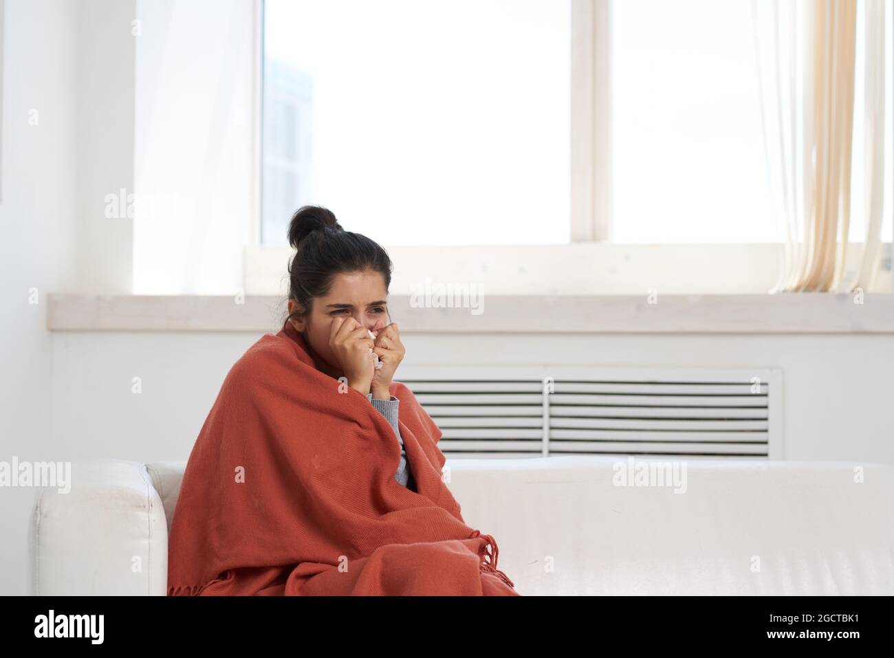 disgruntled woman and lies at home on the couch for colds Stock Photo ...