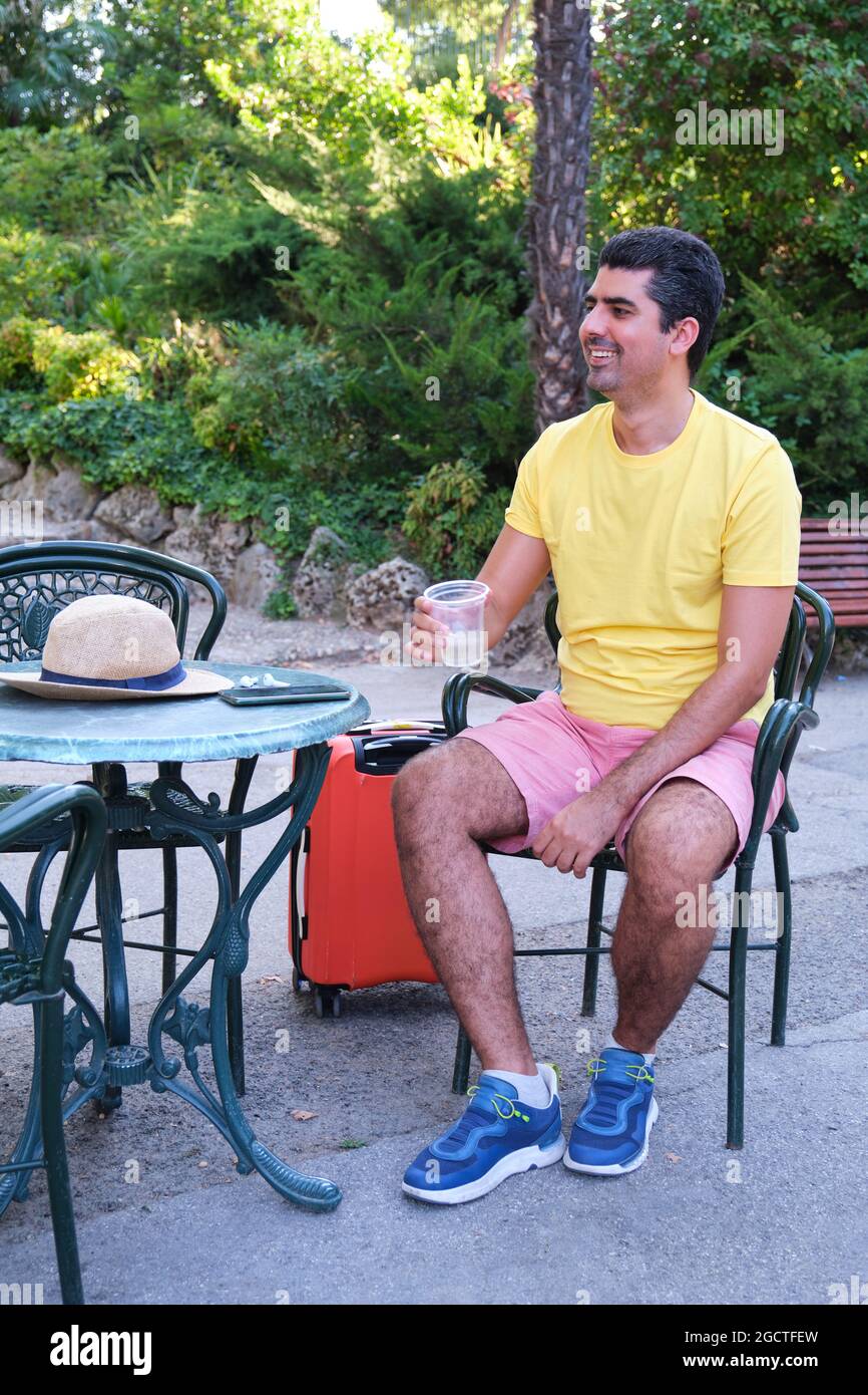 Tourist resting drinking a refreshment and sitting on a bar summer ...