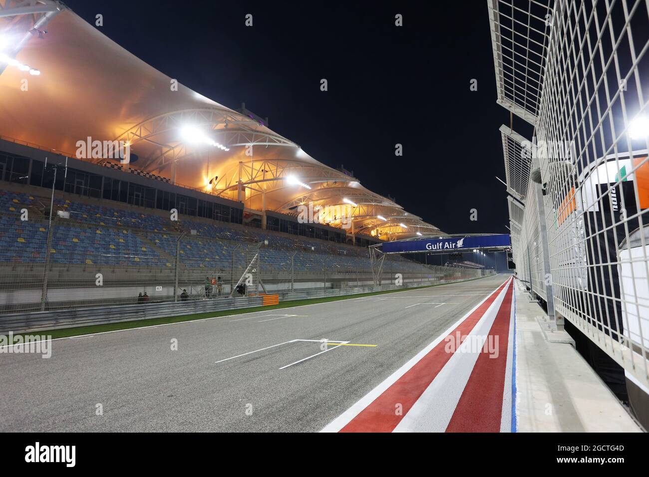The pit straight under floodlights at night. Bahrain Grand Prix ...
