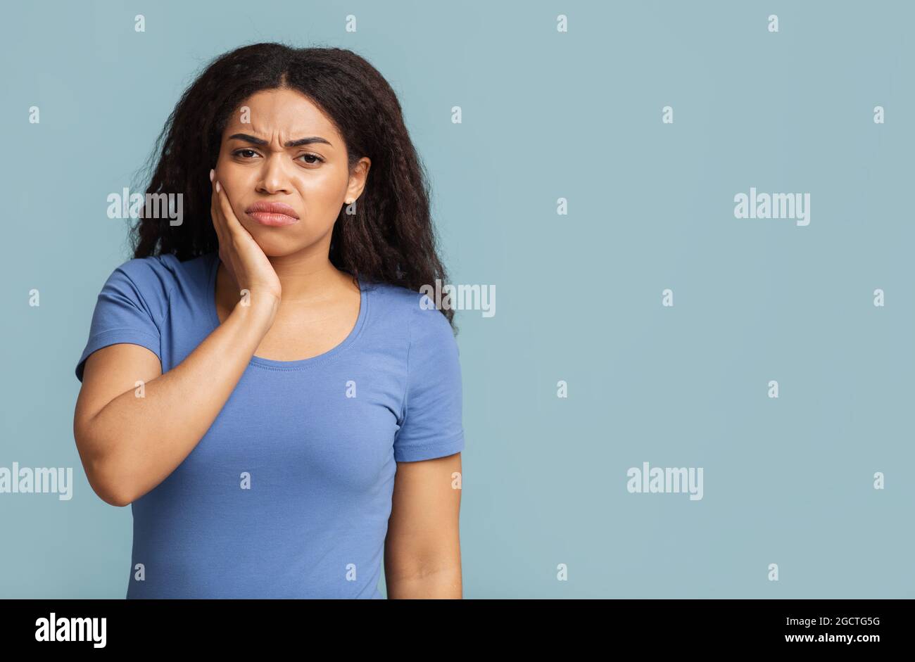 Aching teeth. Unhappy black lady suffering from toothache pain touching ...