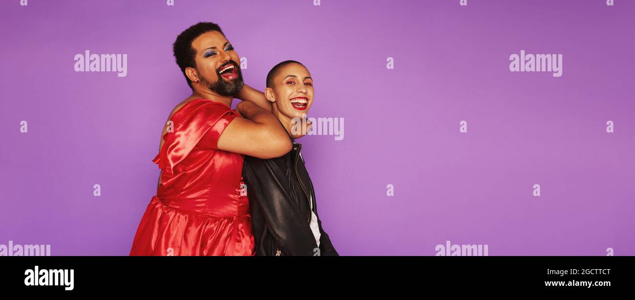 Cheerful lgbt friends together on purple background. Drag queen with ...