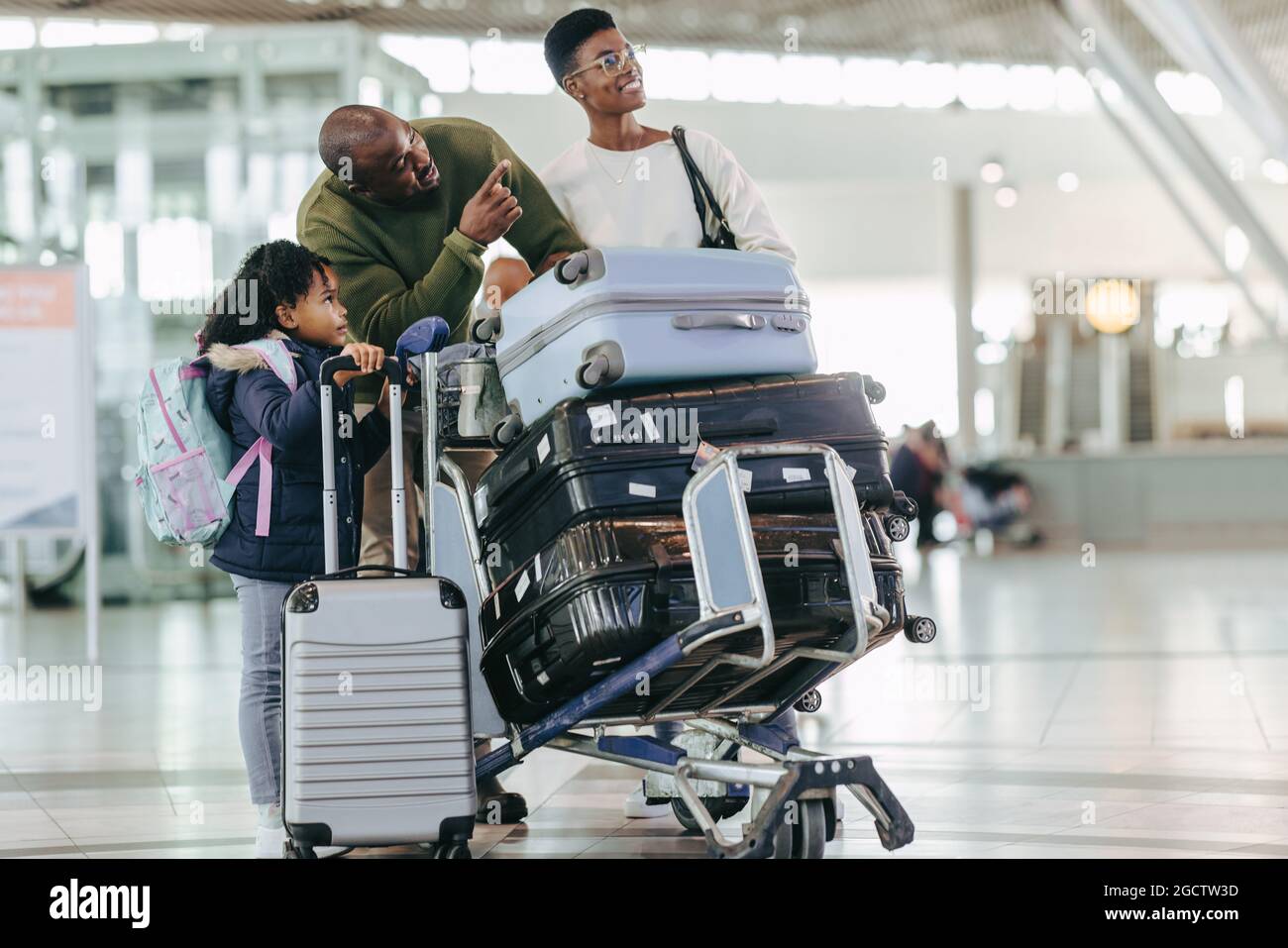 Dad showing the flight information board to his daughter standing at ...