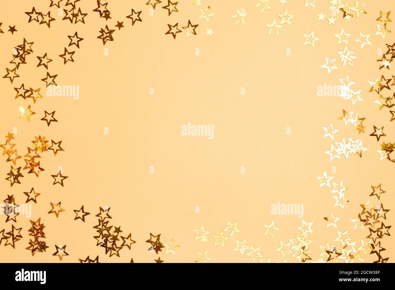 Border frame made of stars confetti on a gold background Stock Photo ...