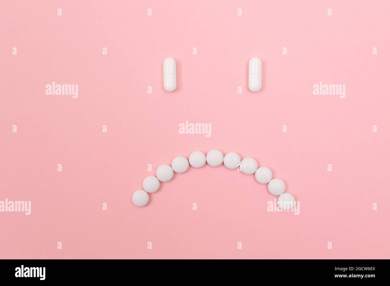Pharma Harm. Sad Smiley Face Made from White Pills, Lying on Pink ...