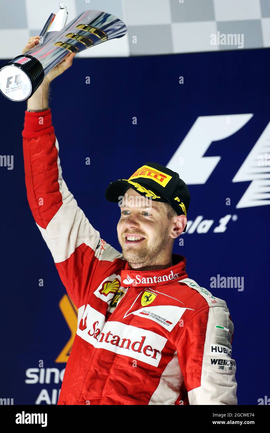 Race winner Sebastian Vettel (GER) Ferrari celebrates on the podium ...
