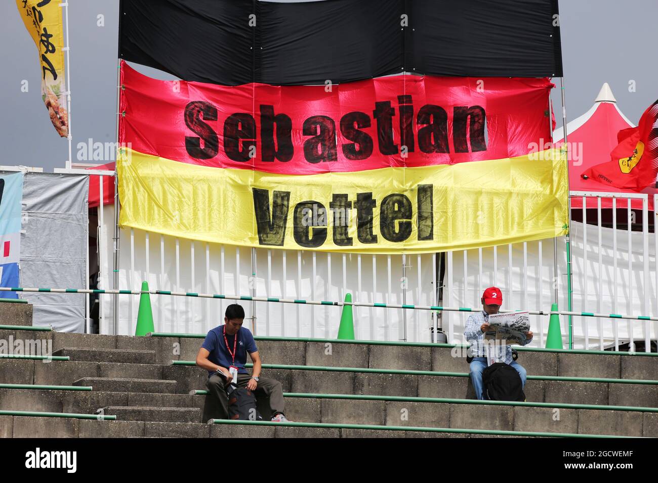 Fans in grandstand a banner for sebastian vettel hi-res stock ...