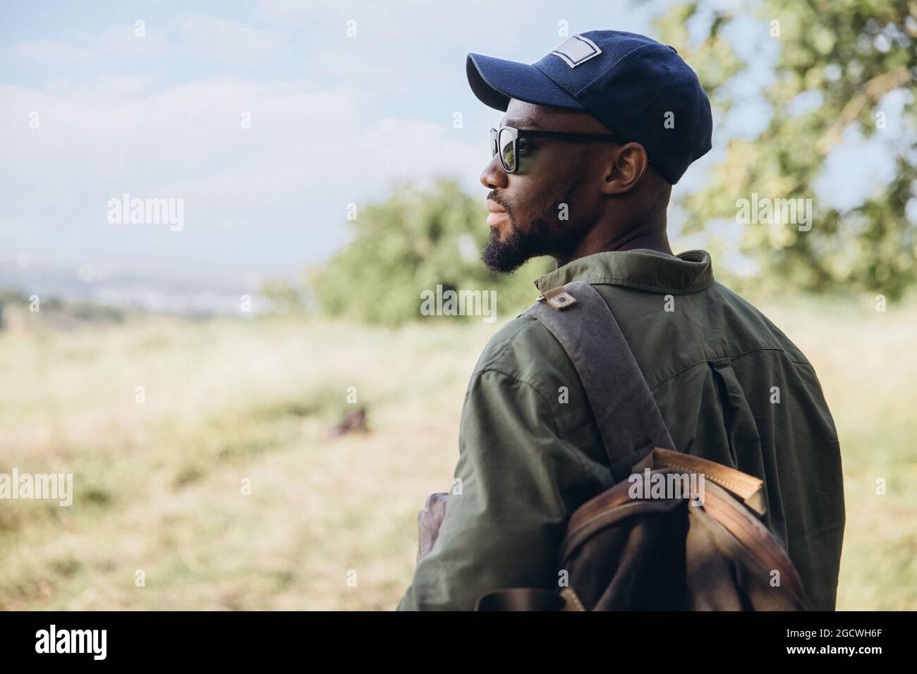 In summer in nature. Close-up young african man walking, strolling ...