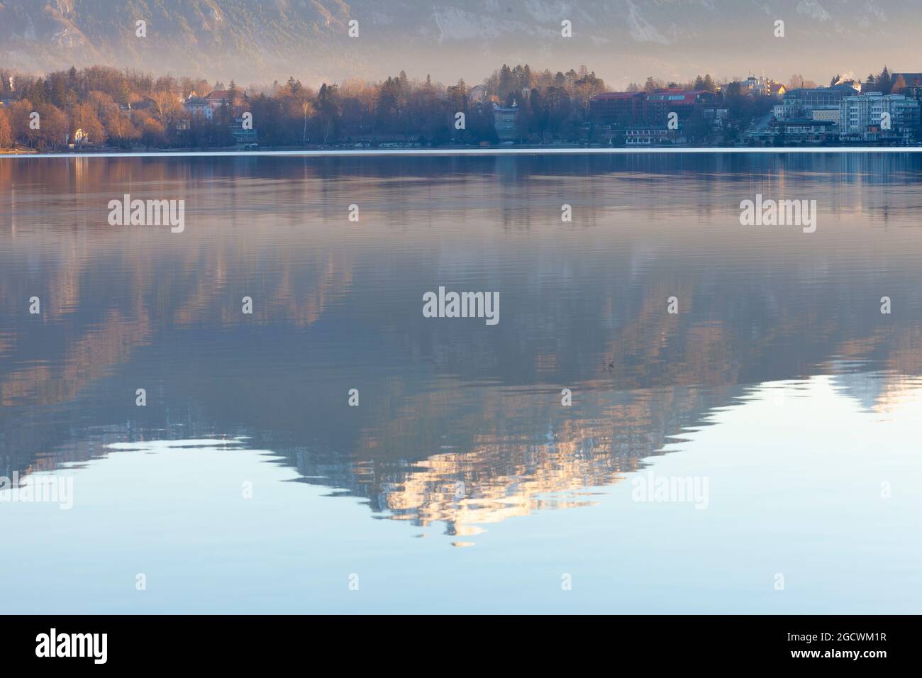 Mountain top reflected Lake Bled (Blejsko jezero) at Sunrise in winter ...