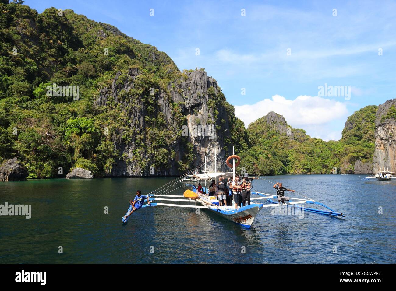 PALAWAN, PHILIPPINES - DECEMBER 1, 2017: Tourists ride outrigger bangka ...