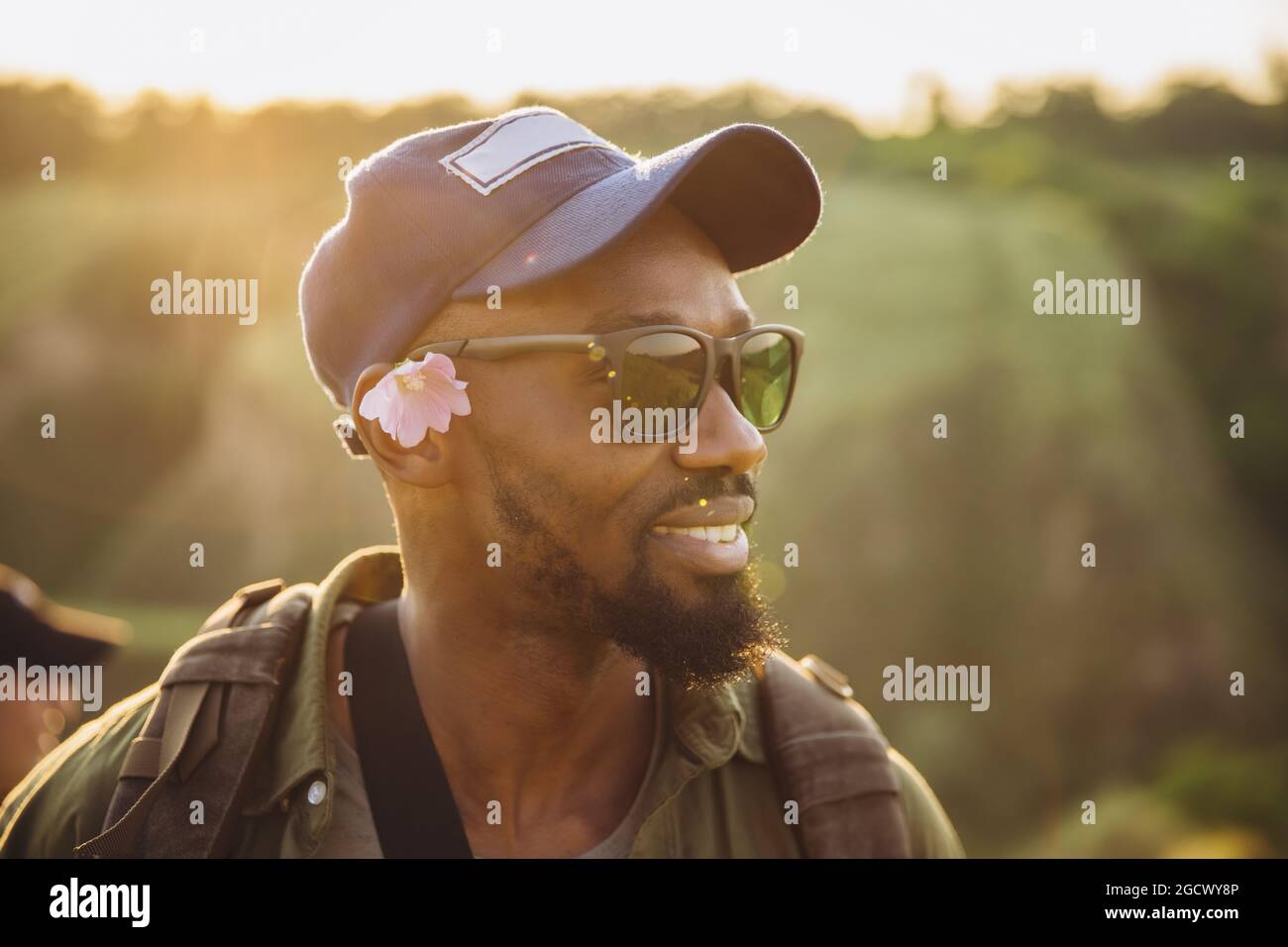 In summer in nature. Close-up young african man walking, strolling ...