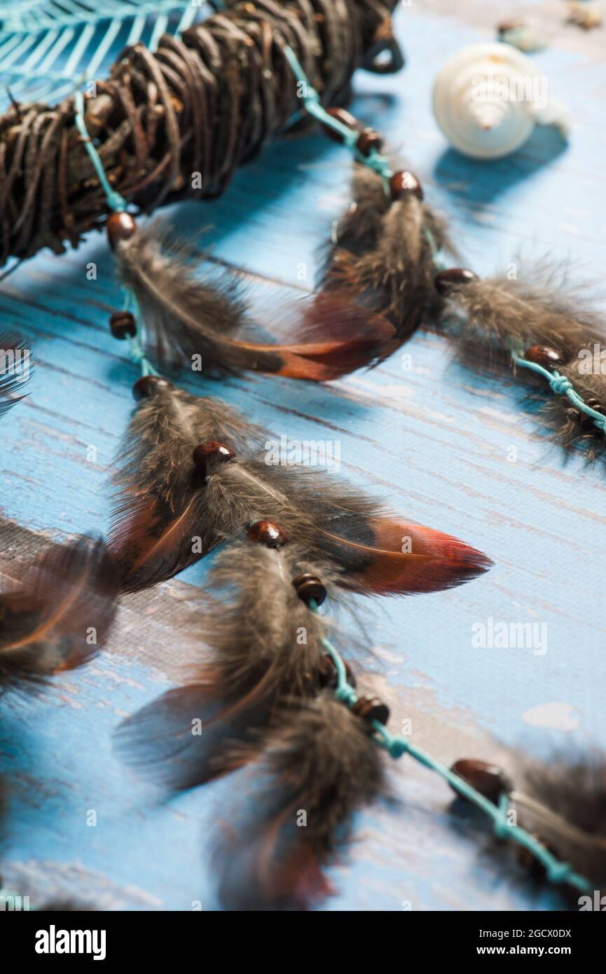 Dream catcher with feathers on blue shabby wooden background. Nautical ...