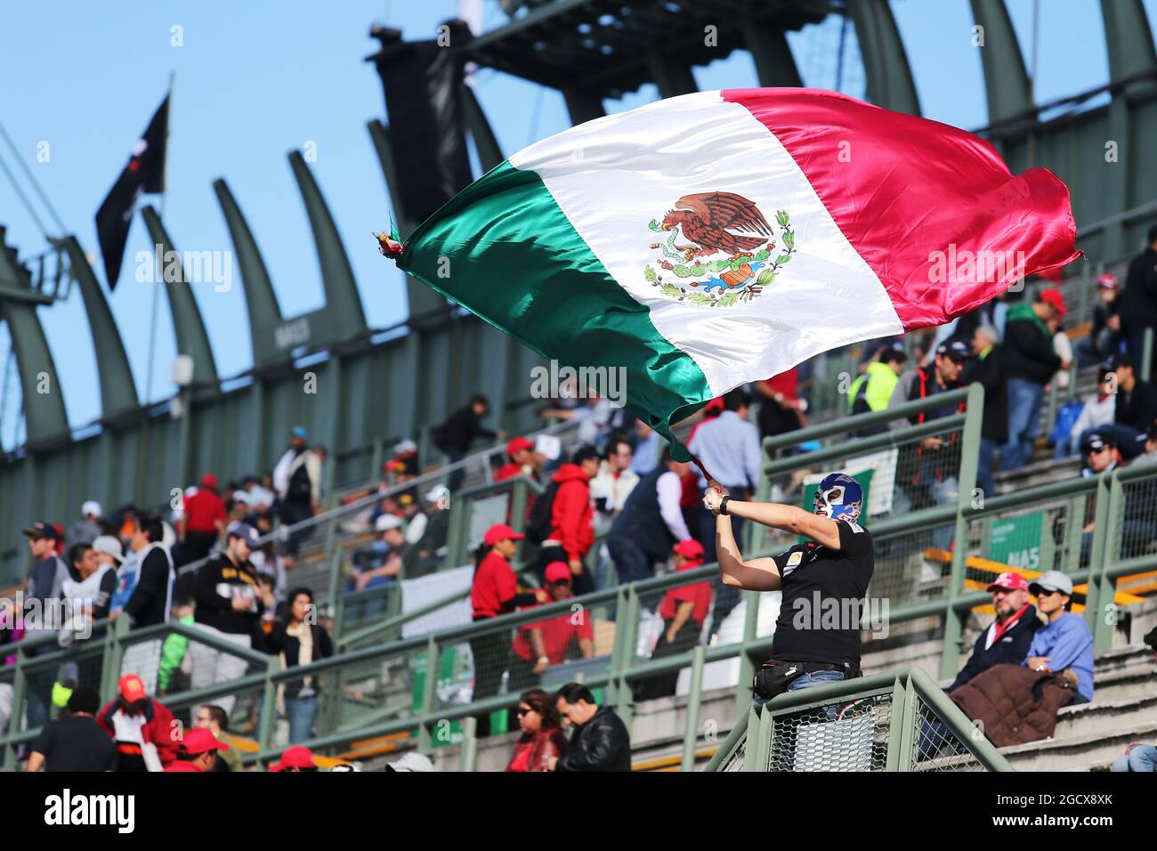 Fans in the grandstand and a man with a Mexican flag. Mexican Grand ...