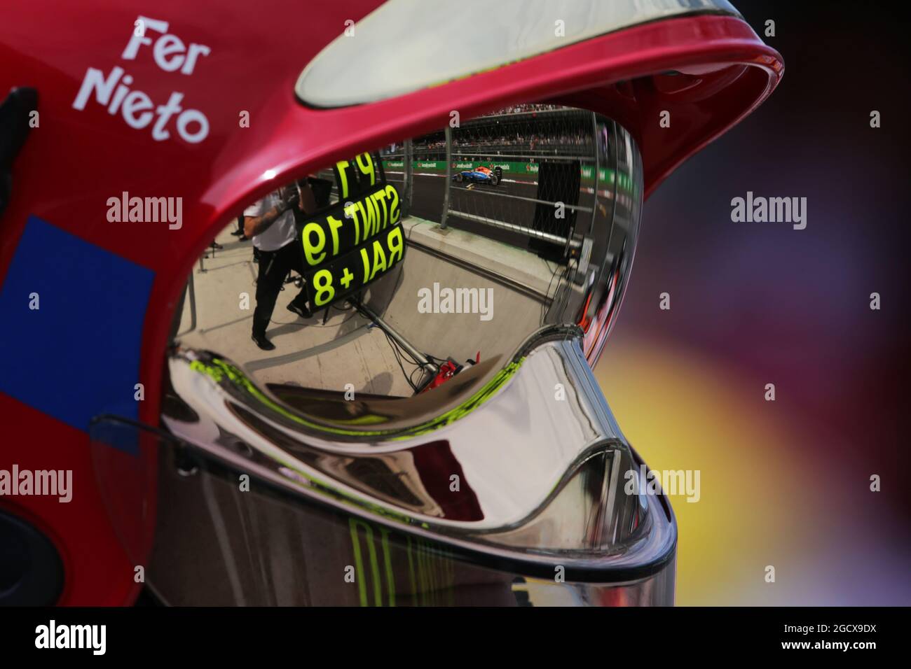 Manor racing mrt05 reflected in a fire marshals visor hi-res stock ...