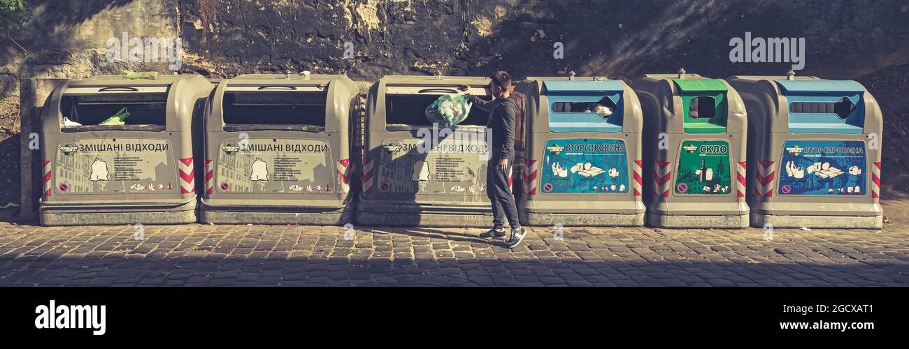 Row of trash cans for sorted garbage to recycling. Man throws litter ...