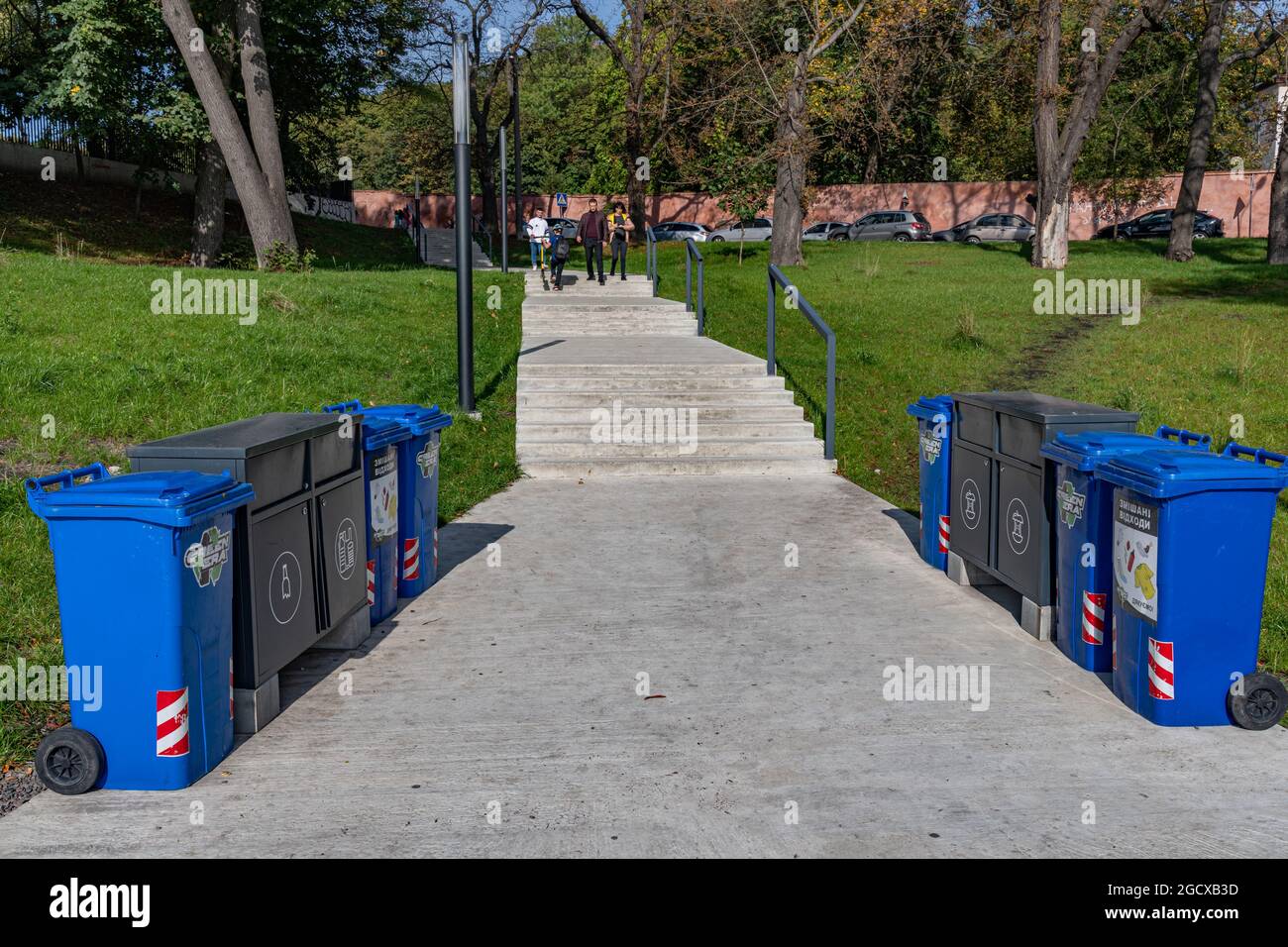 Pavement and stairs in park with trash recycling cans for sorted ...