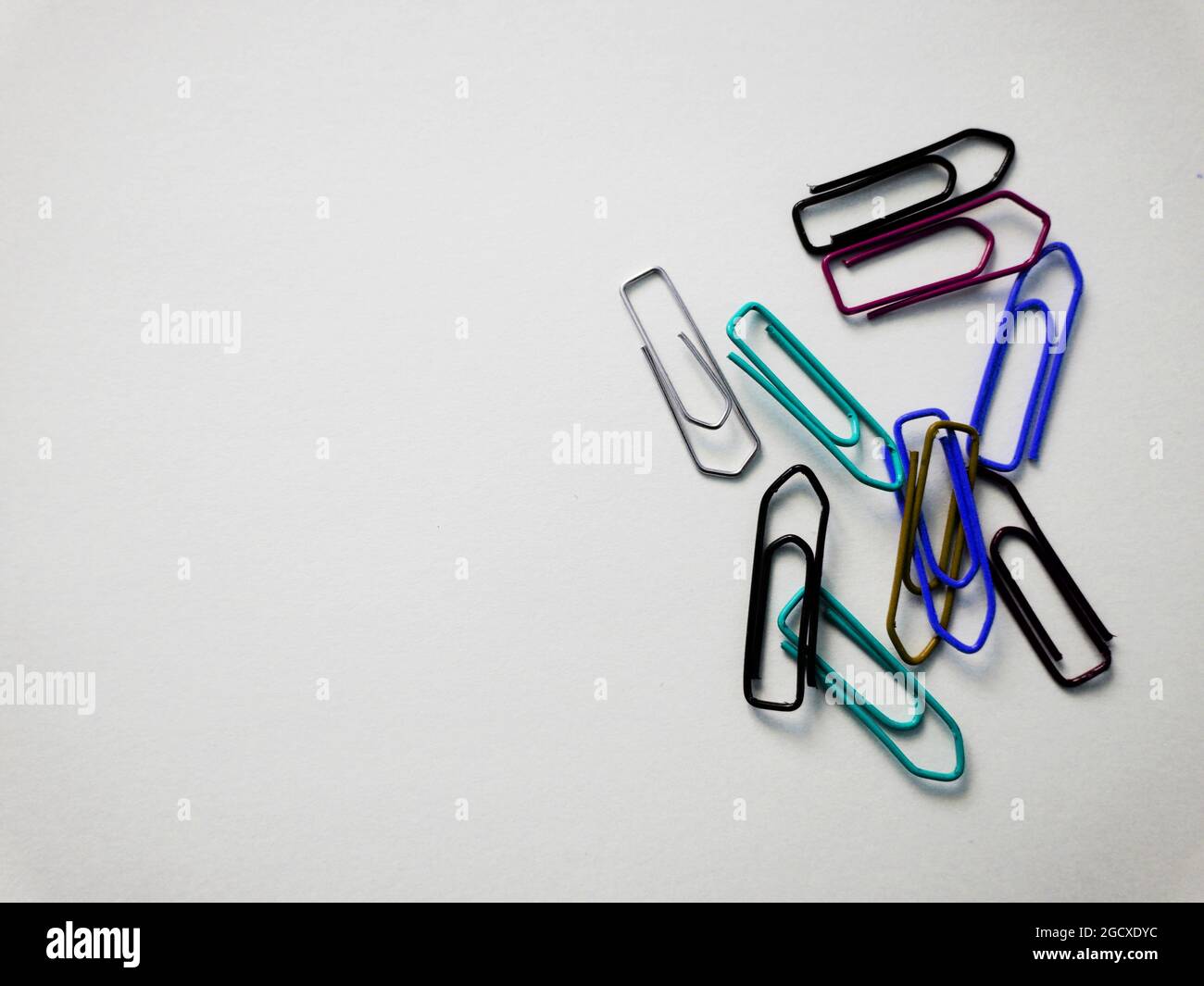 Paper clips on white background Stock Photo - Alamy