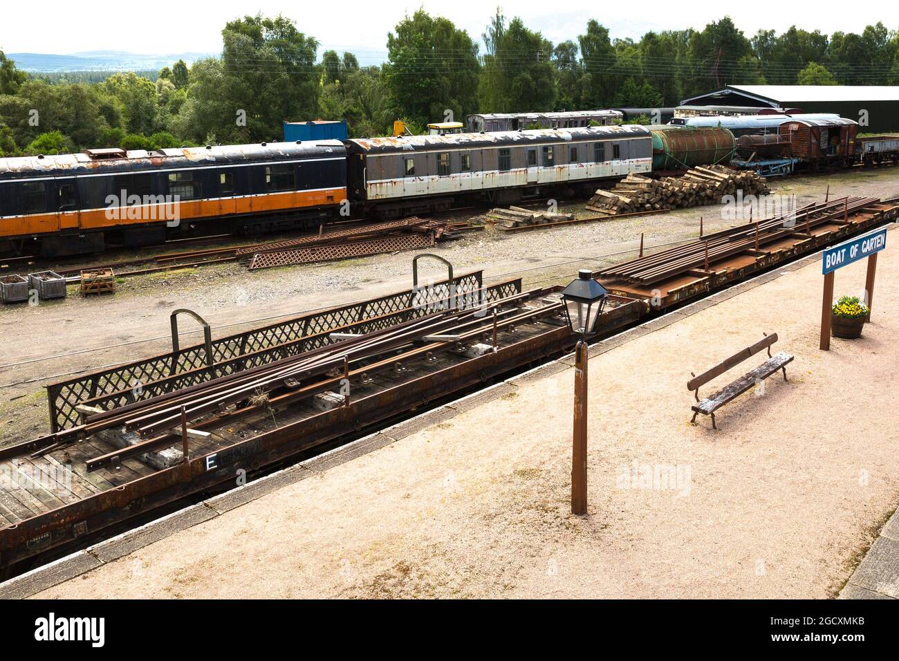 steam railway, station yard. Spare rails stored on old rolling stock ...