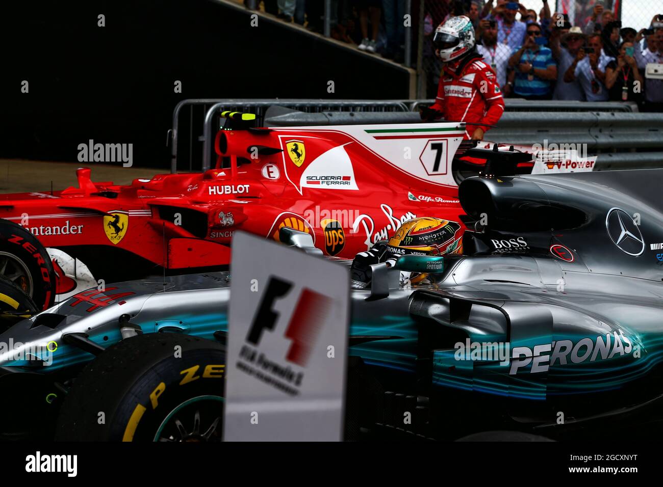 Sebastian Vettel (GER) Ferrari in parc ferme as race winner Lewis ...