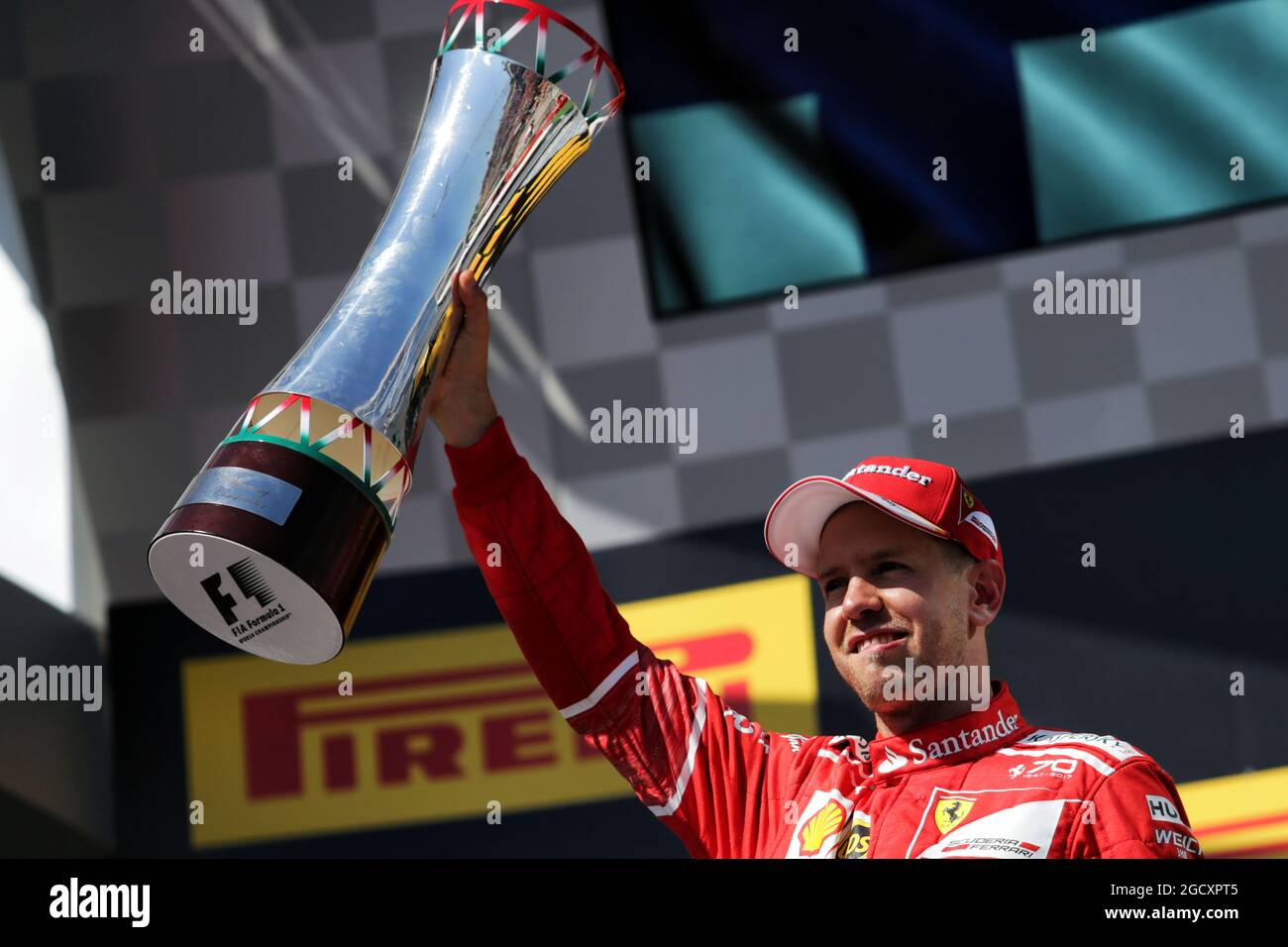 Race winner Sebastian Vettel (GER) Ferrari celebrates on the podium ...