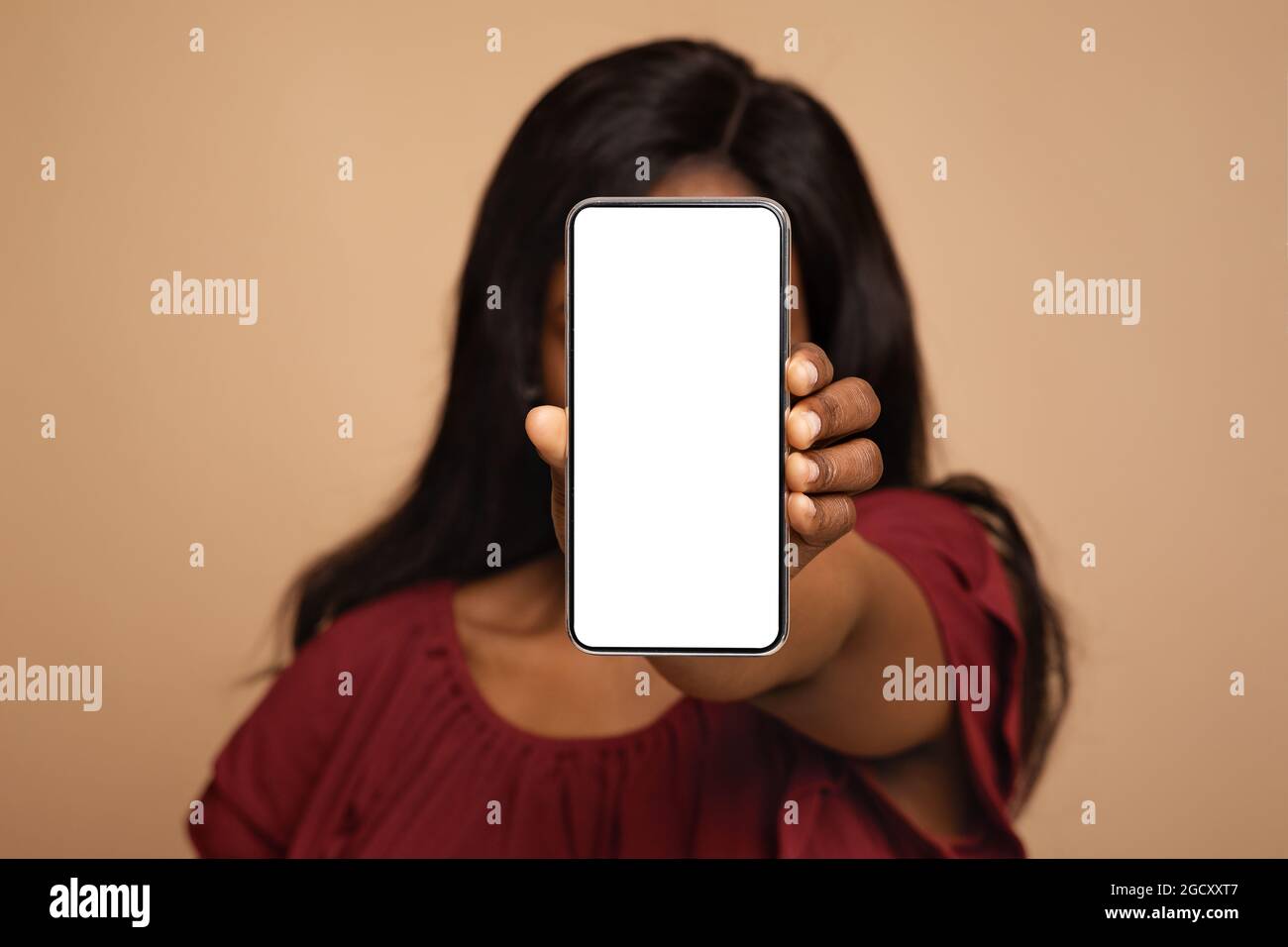 Black lady covering her face with empty screen cellphone, mockup Stock ...