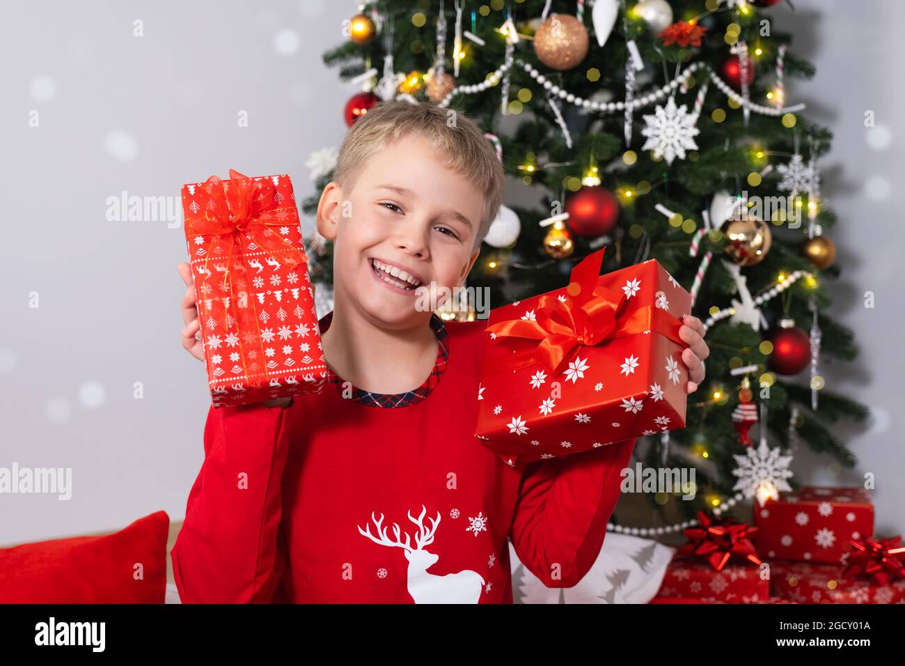 Happy boy near christmas tree hi-res stock photography and images - Alamy