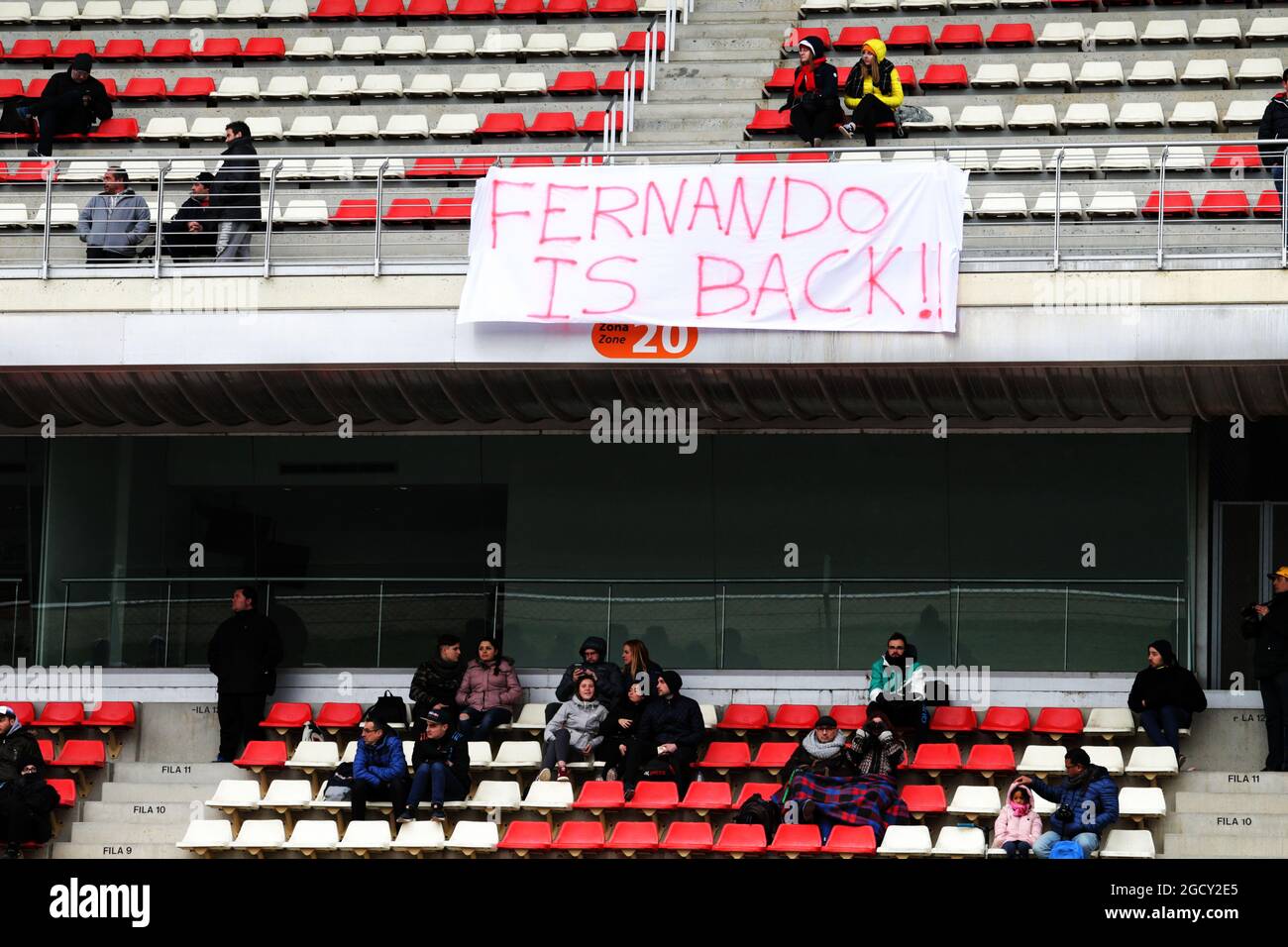A banner for Fernando Alonso (ESP) McLaren with fans in the grandstand ...