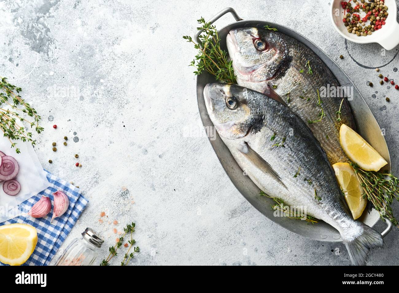 Raw dorado fresh fish or sea bream with ingredients for making lemon ...