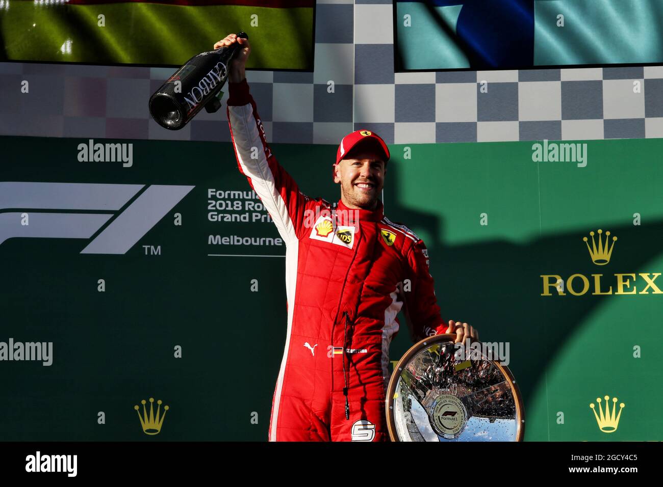 Race winner Sebastian Vettel (GER) Ferrari celebrates on the podium ...