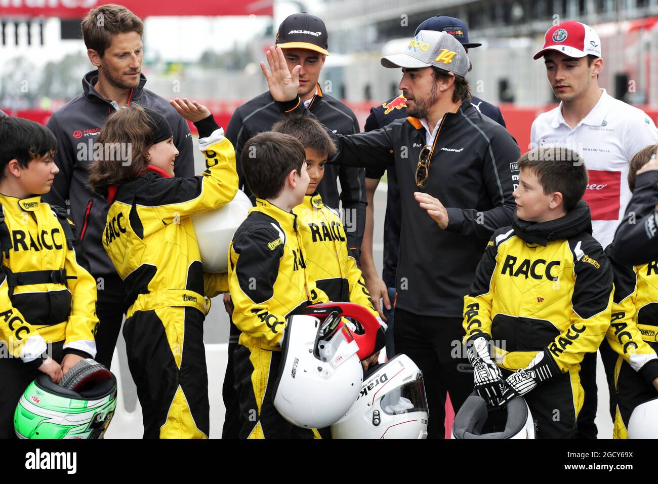 Fernando Alonso (ESP) McLaren with karting kids. Spanish Grand Prix ...