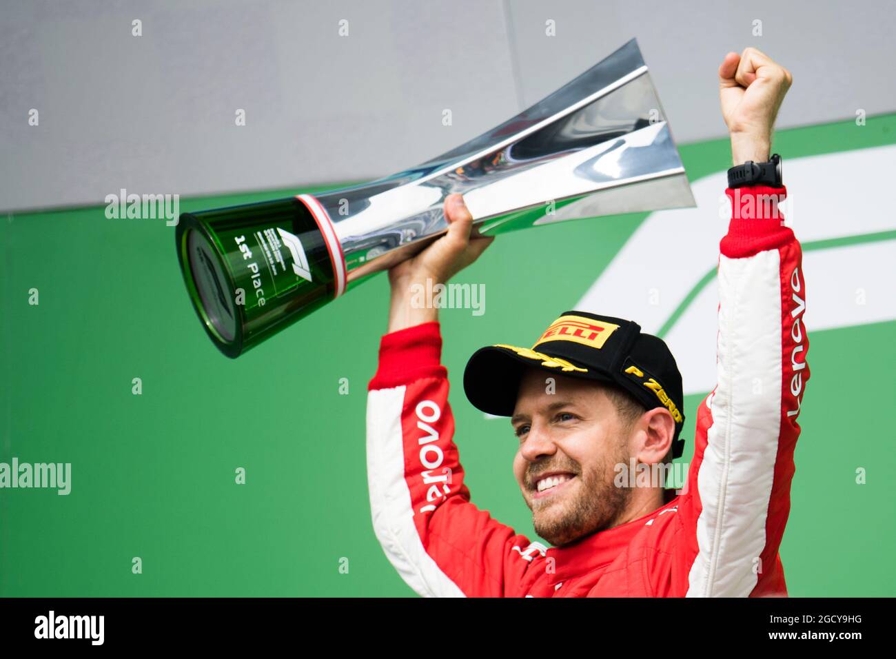 Race winner Sebastian Vettel (GER) Ferrari celebrates on the podium ...