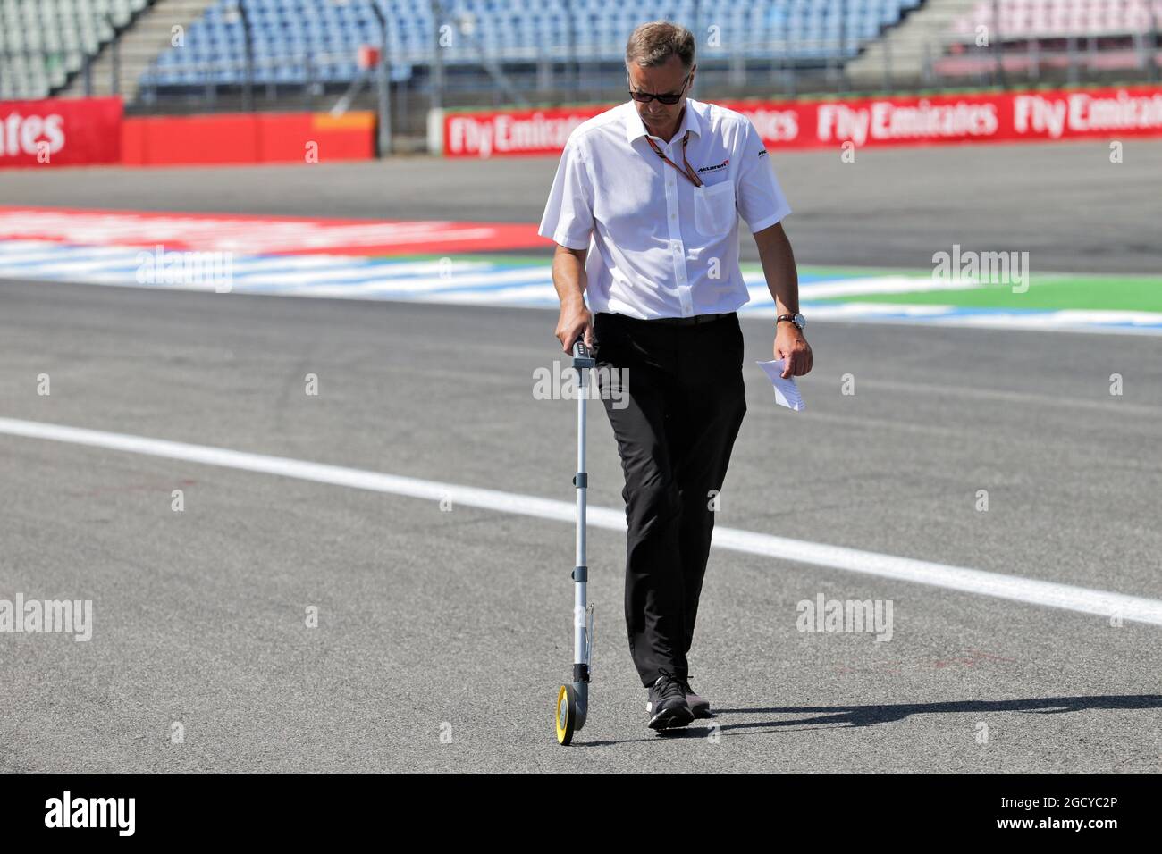 McLaren engineer measures the pit lane exit. German Grand Prix ...