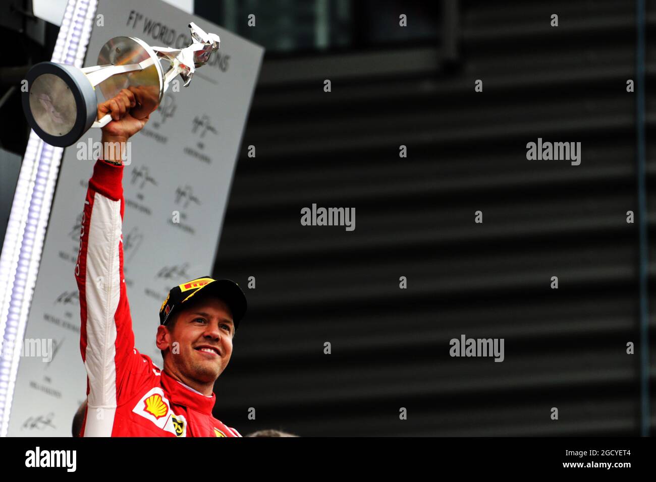 Race winner Sebastian Vettel (GER) Ferrari celebrates on the podium ...