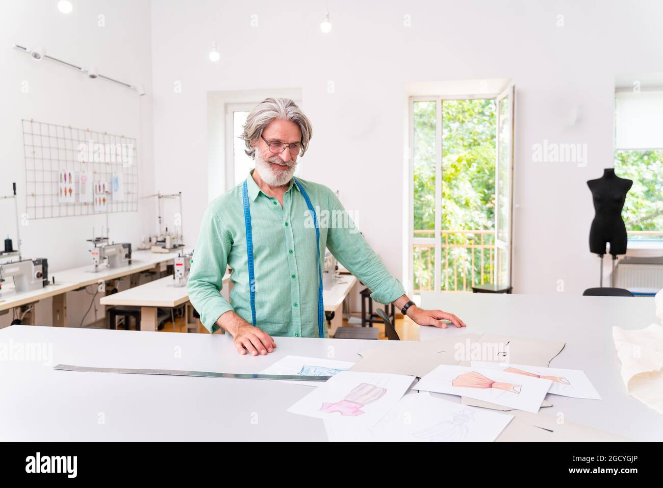 Clothing stylist creating a new design for a dress - Fashion designer ...