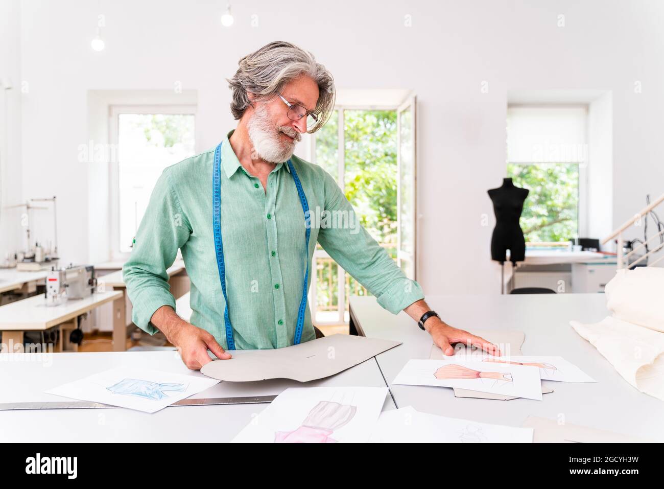 Clothing stylist creating a new design for a dress - Fashion designer ...