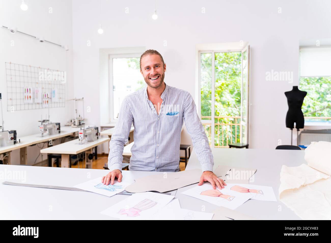 Clothing stylist creating a new design for a dress - Fashion designer ...