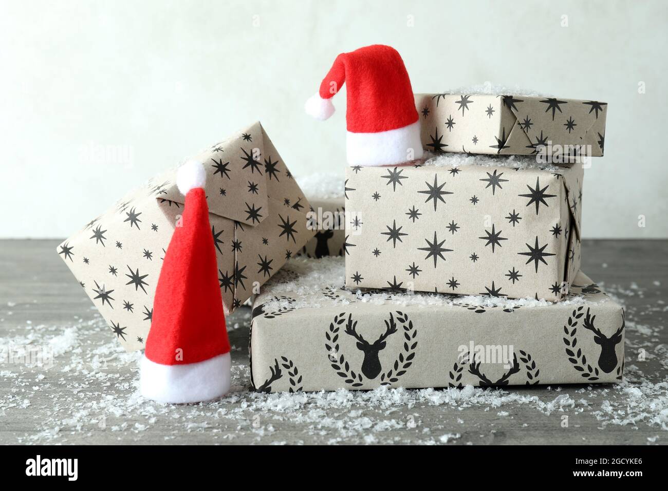 Santa hats and gift boxes on gray textured table Stock Photo - Alamy