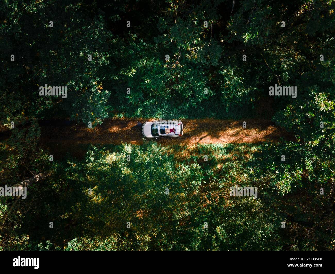 aerial view woman laying down on suv car roof in the middle of the ...